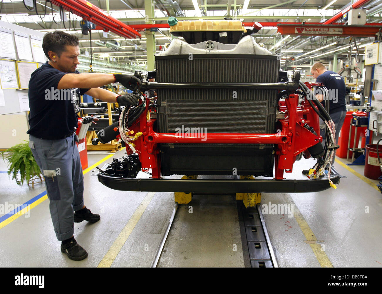 Workers assemble a lorry at the MAN manufacturing plant in Salzgitter ...