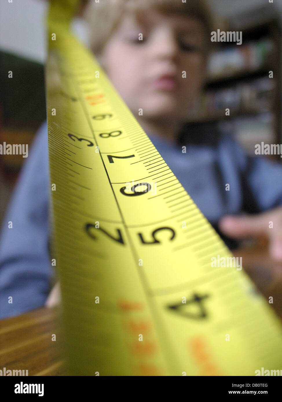 A young boy looks at a measuring tape, Frankfurt Main, Germany, 07 July ...