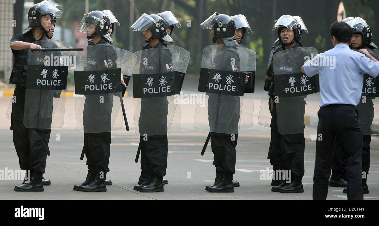Chinese policemen stand in a row during an exercise at Shanghai Stadium ...