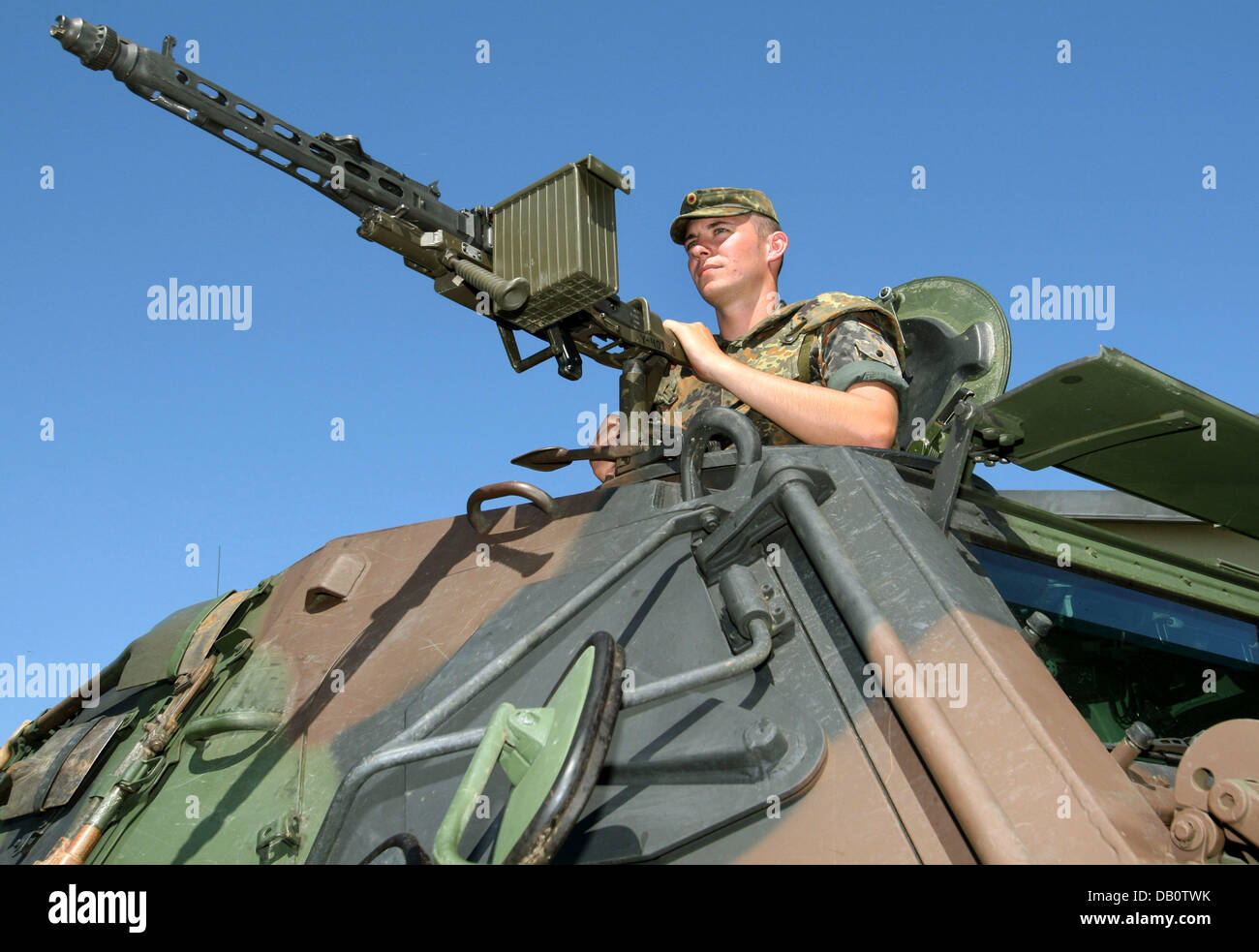 A soldier stand at a gun in a type 'Fuchs' tank of the 10th armoured ...