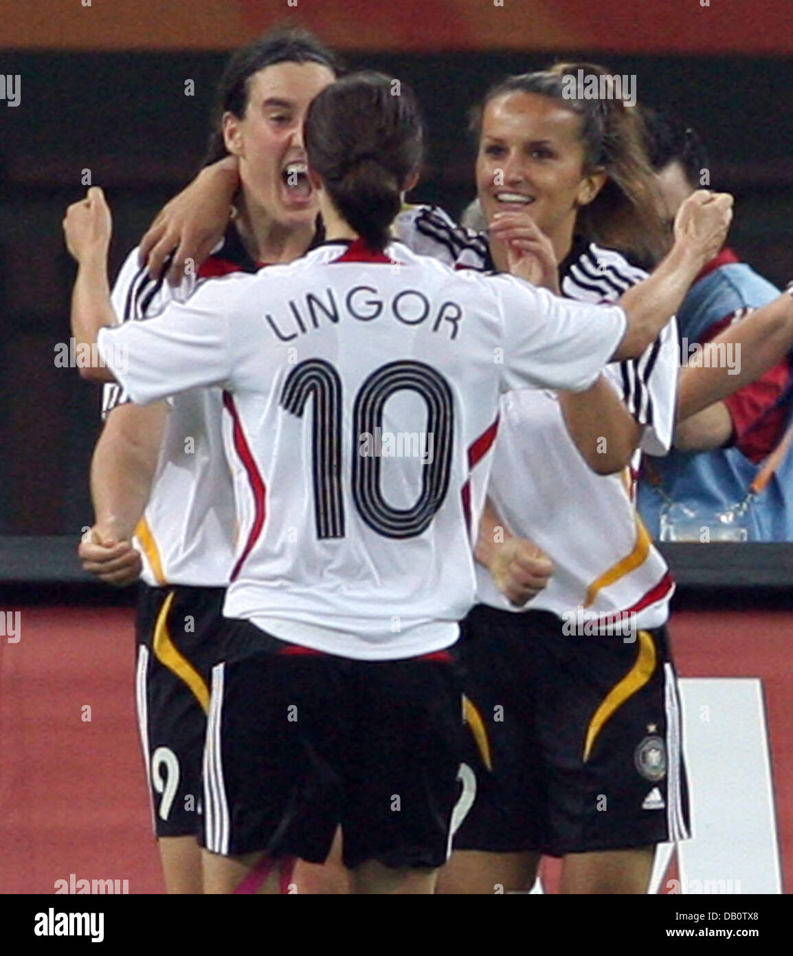 Germany's Birgit Prinz (L-R) cheers with herr teammates Renate Lingor ...