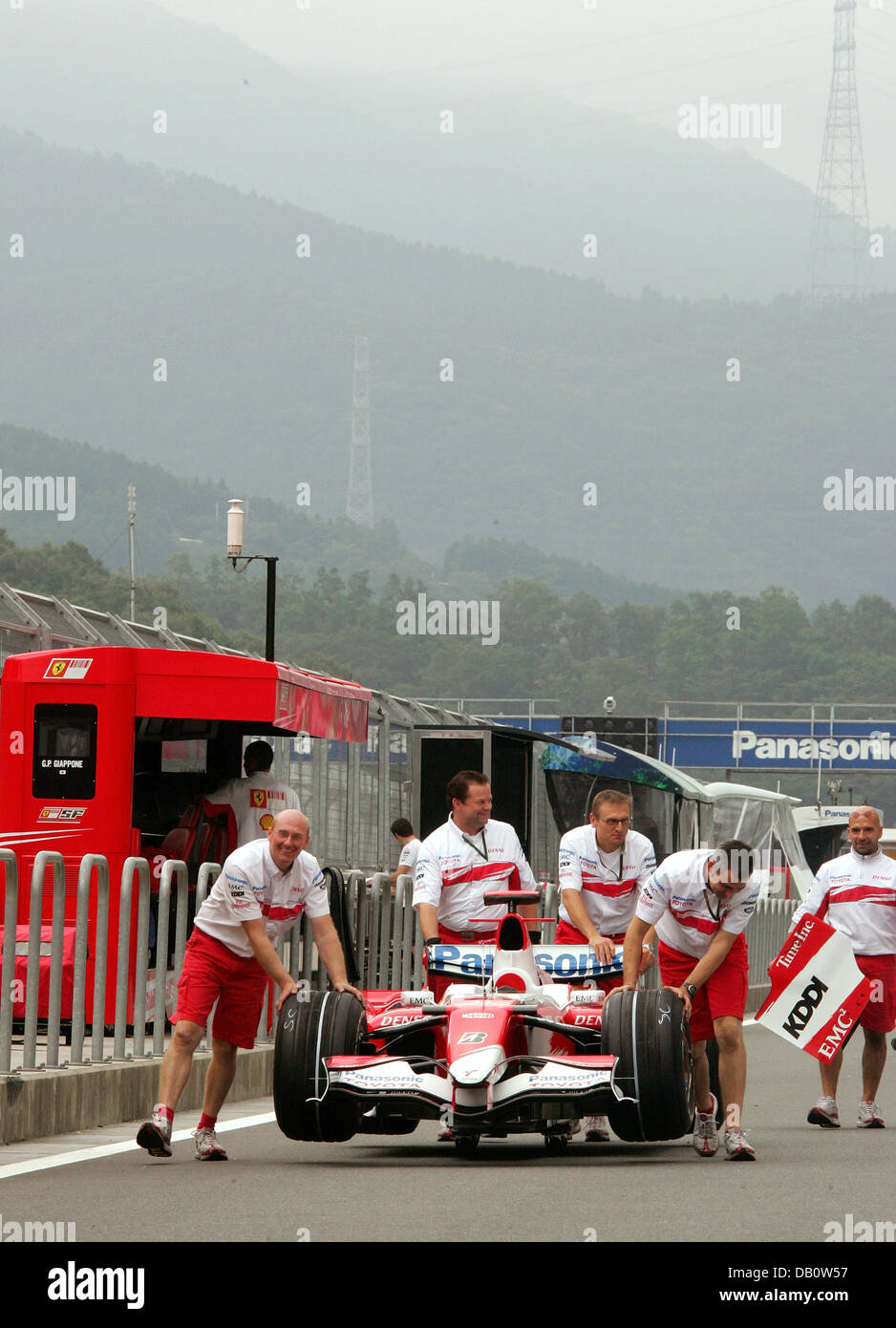 Mechanis of Toyota push a race car through the pit lane of Fuji ...