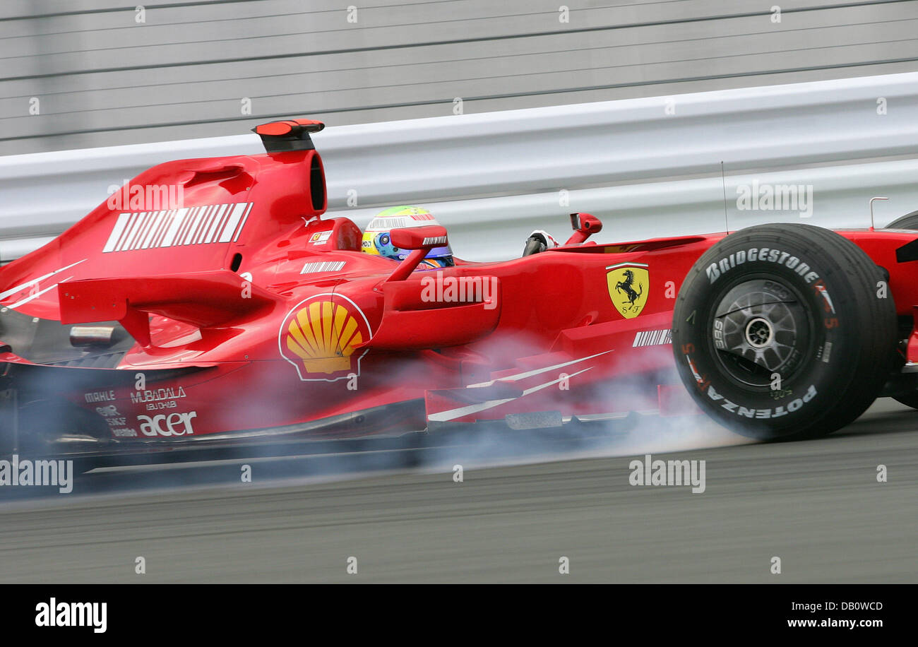 Finish Formula One pilot Kimi Raikkonen of Ferrari breaks as smoke ...