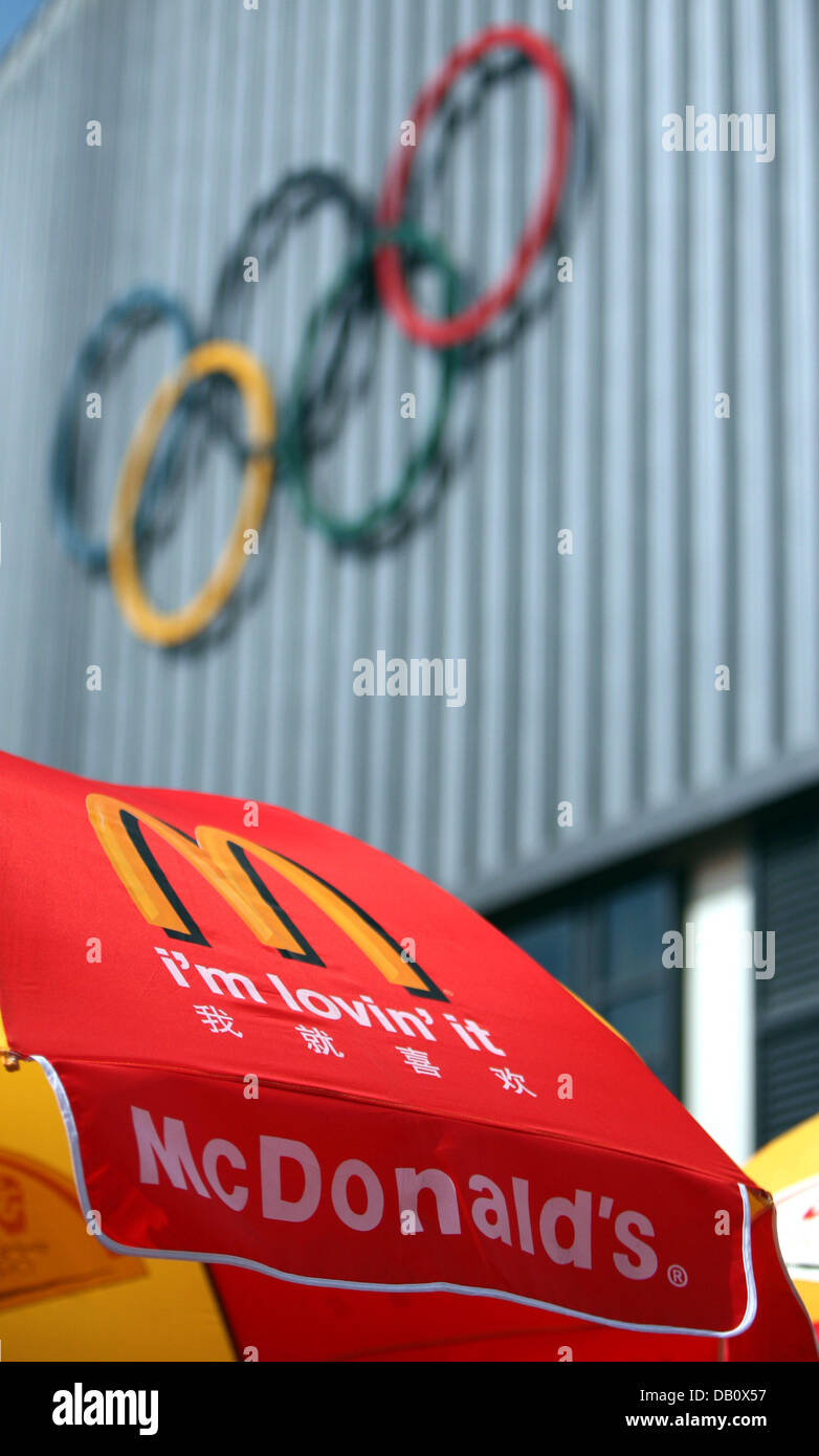 The picture shows an umbrella by fast-food chain McDonald's next to the ...