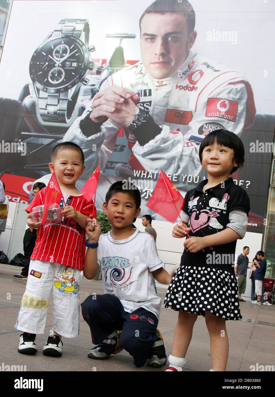 Chinese children pose with their national flags in front of a giant ...