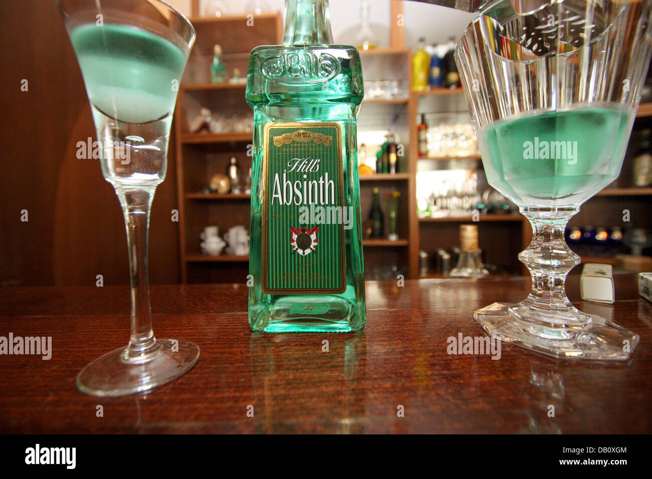 A bottle and two glasses filled with absinthe are pictured at the ...