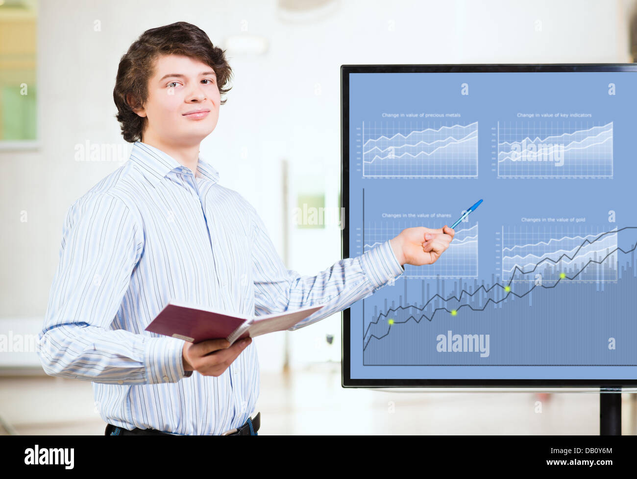young business man shows on the monitor charts Stock Photo - Alamy