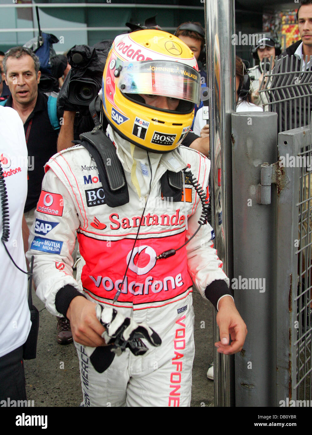 British Formula One pilot Lewis Hamilton of McLaren Mercedes walks back ...