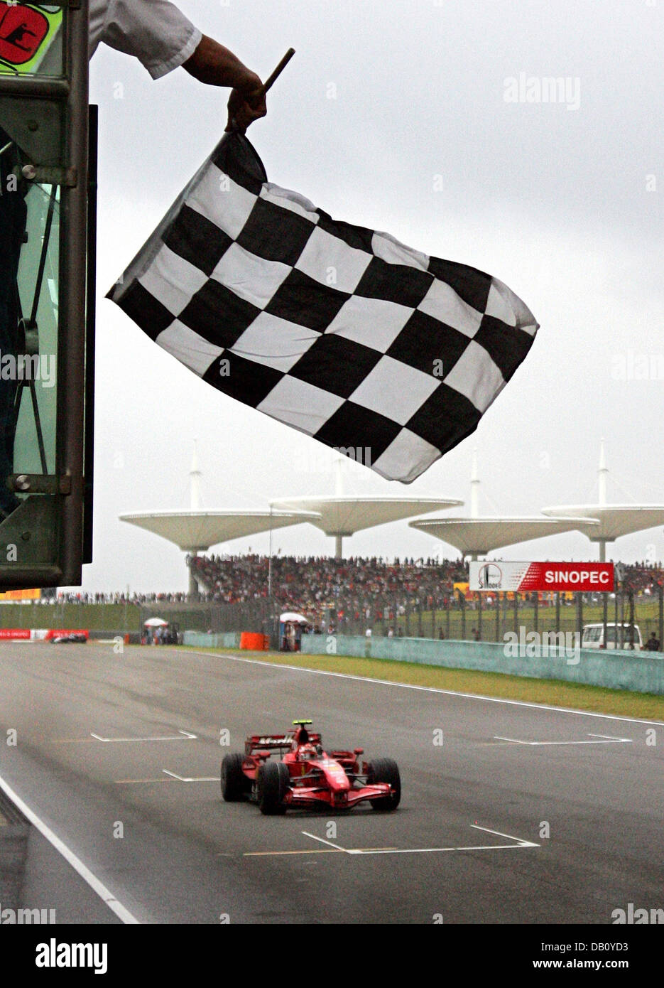Finnish Formula One pilot Kimi Raikkonen of Ferrari crosses the finish ...