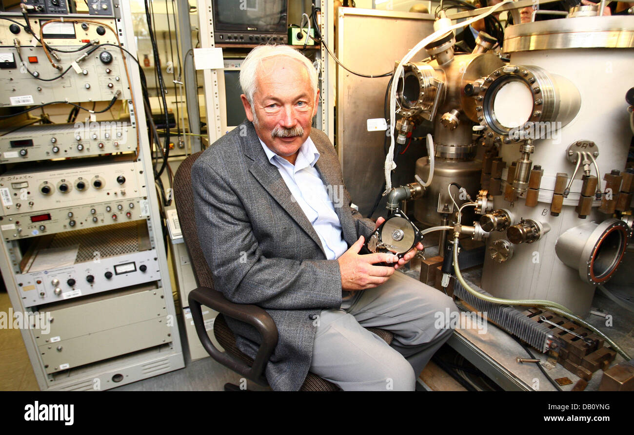 German physicist Peter Gruenberg sits in the laboratory holding a hard ...