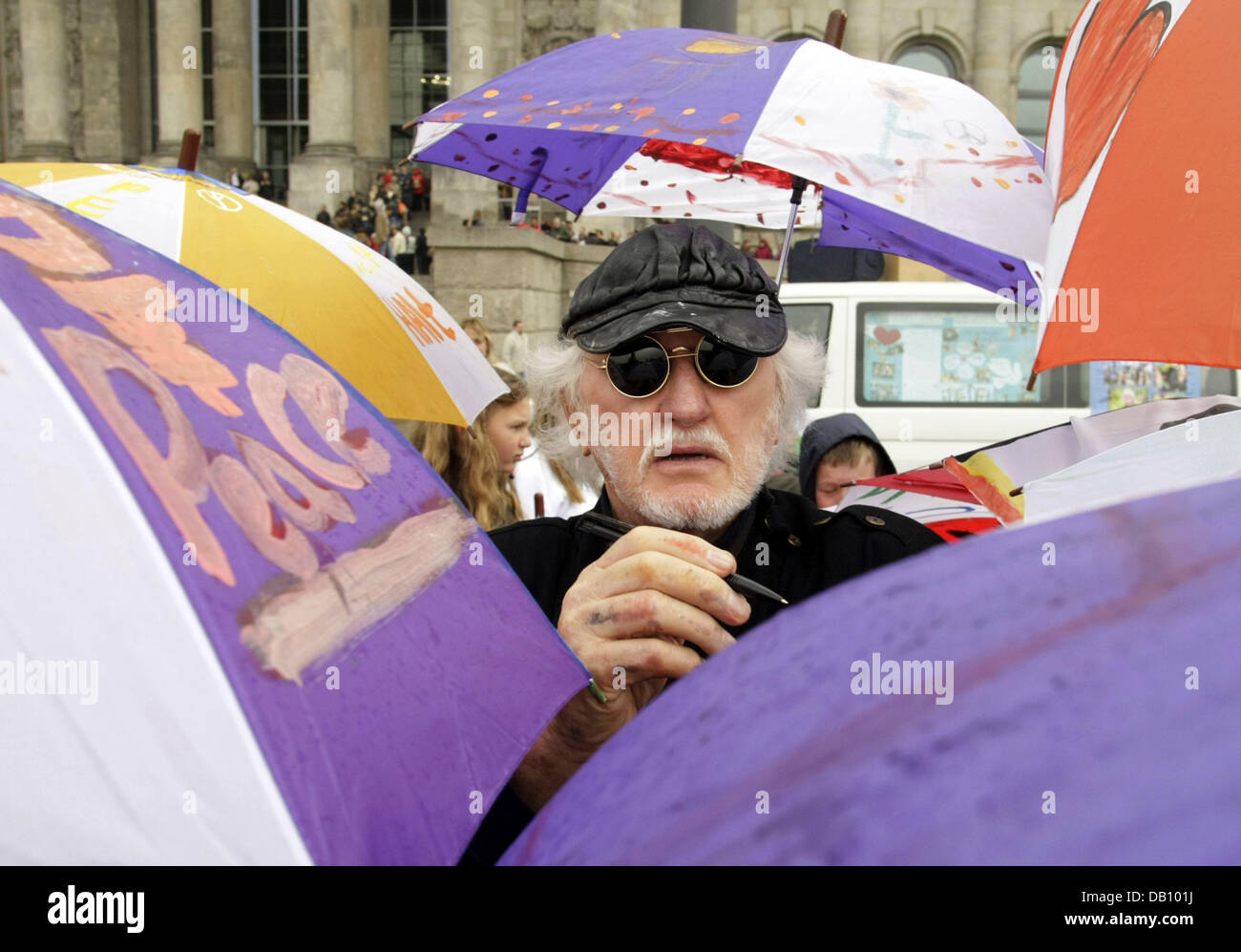 Artist Matt Lamb autographs colourfully painted umrellas in Berlin ...