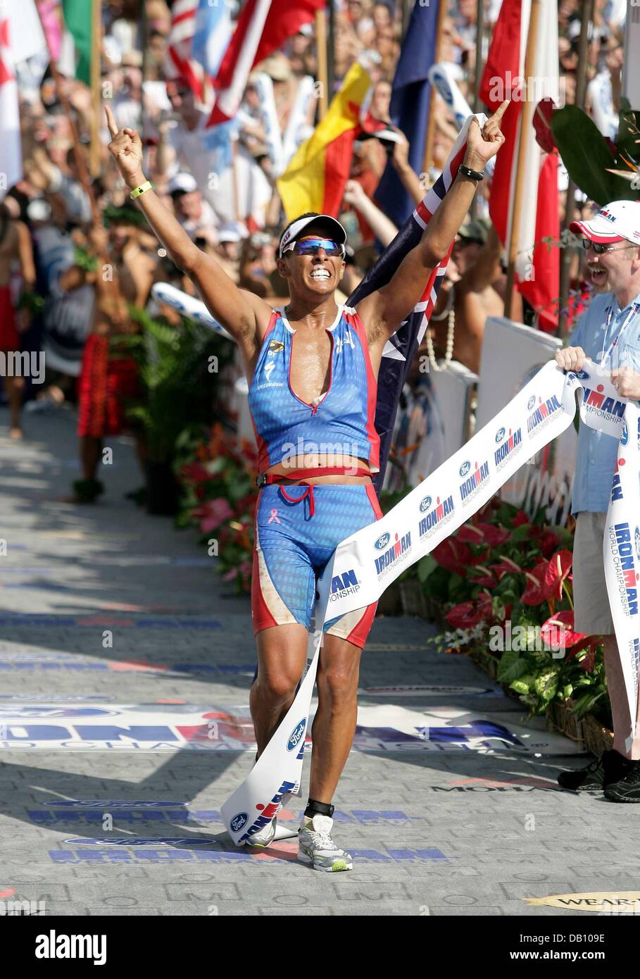 Australian triathlete Chris McCormack crosses the finish line with ...