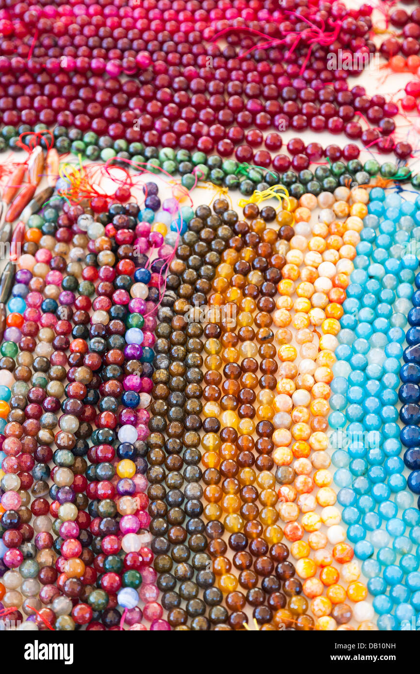 Colourful strings of beads and necklaces on a market stall in Italy ...