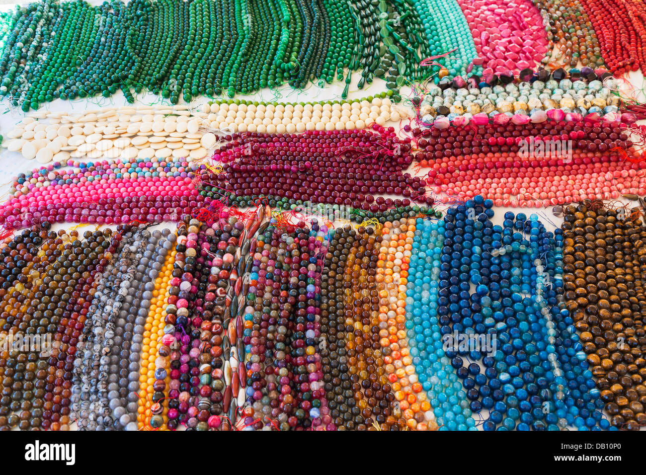 Colourful strings of beads and necklaces on a market stall in Italy ...