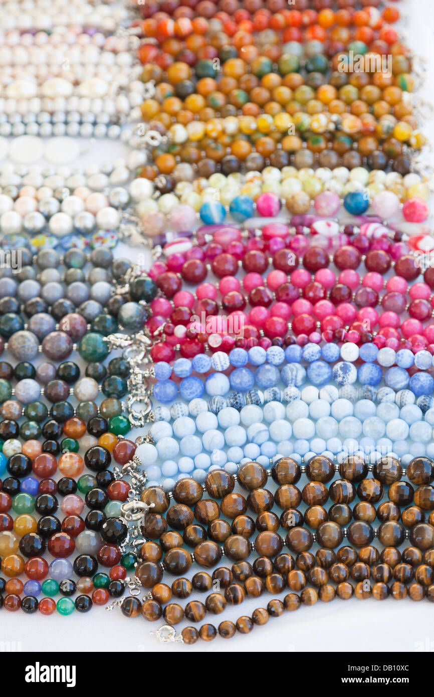 Colourful strings of beads and necklaces on a market stall in Italy ...