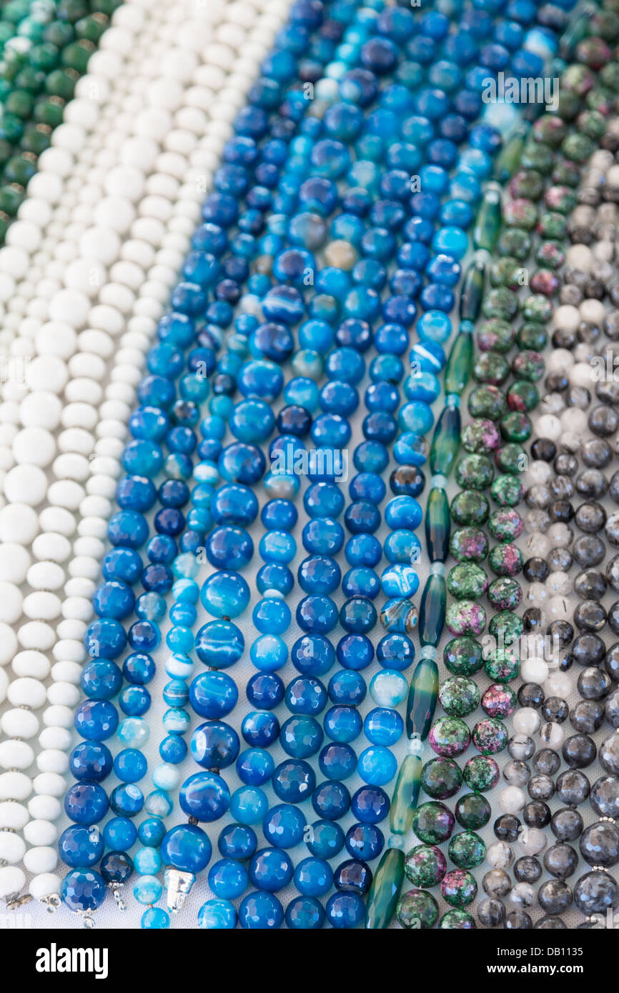 Colourful strings of beads and necklaces on a market stall in Italy ...