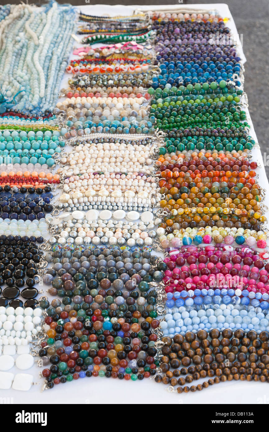 Colourful strings of beads and necklaces on a market stall in Italy ...