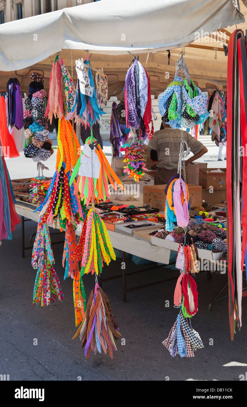 Brightly coloured items and souvenirs on a market stall in Lecce ...