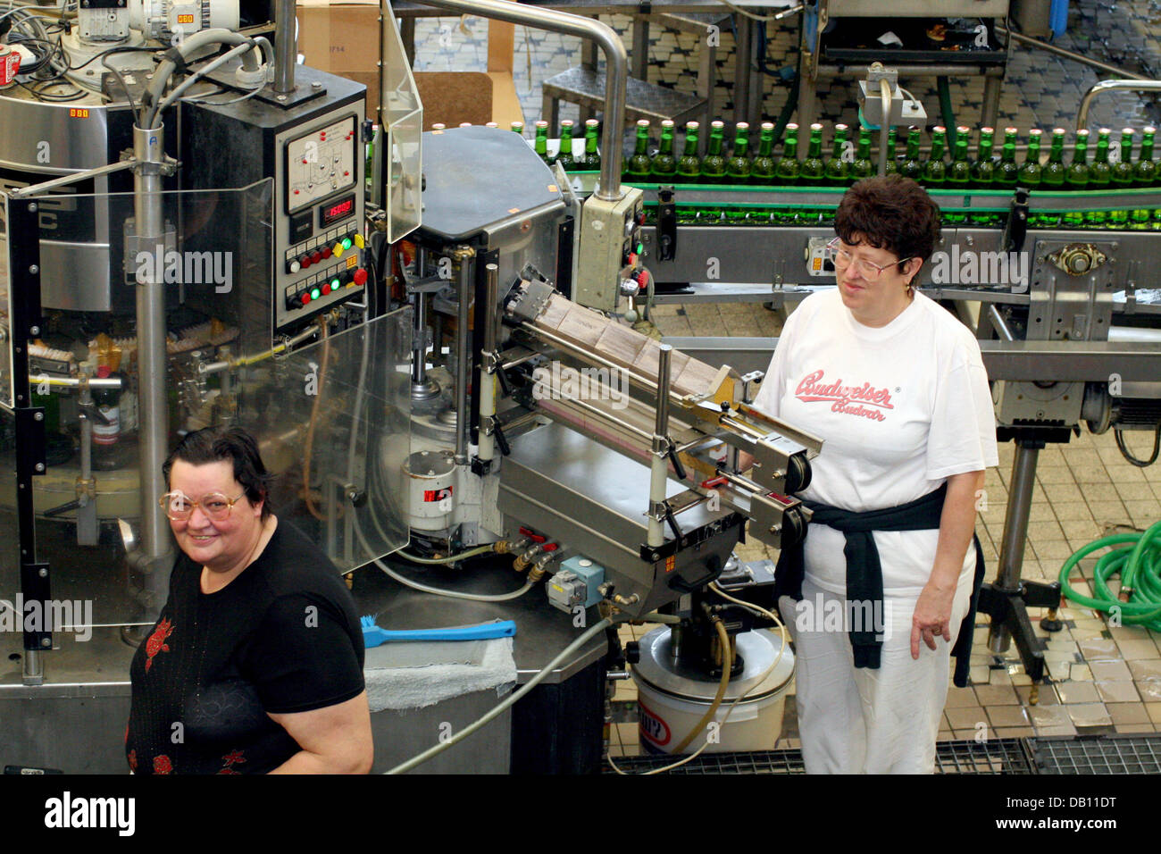 FILE - Two employees survey a bottling installation in the 'Budweiser ...