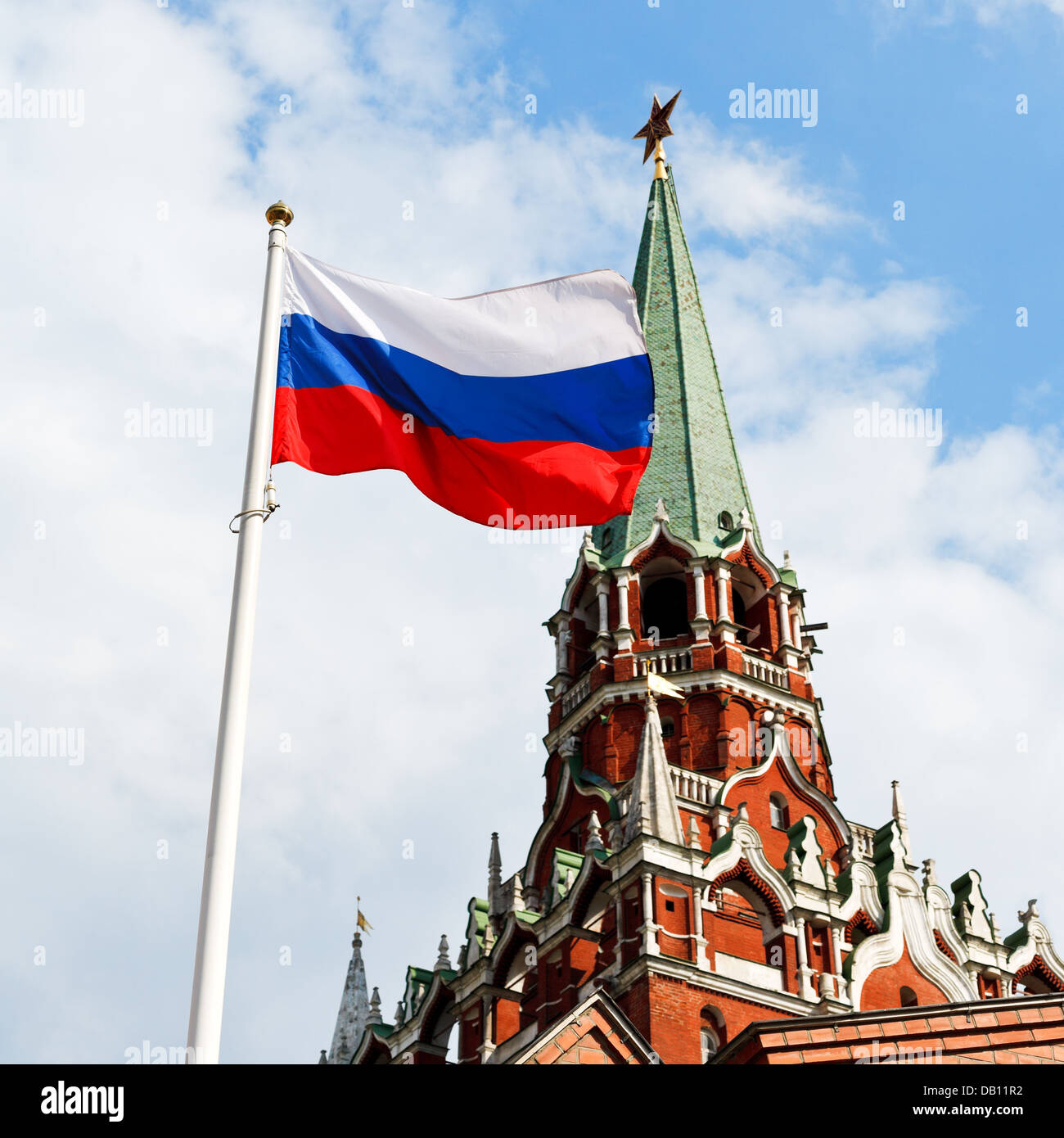 Russian state flag flying in wind with Kremlin Trinity tower on ...
