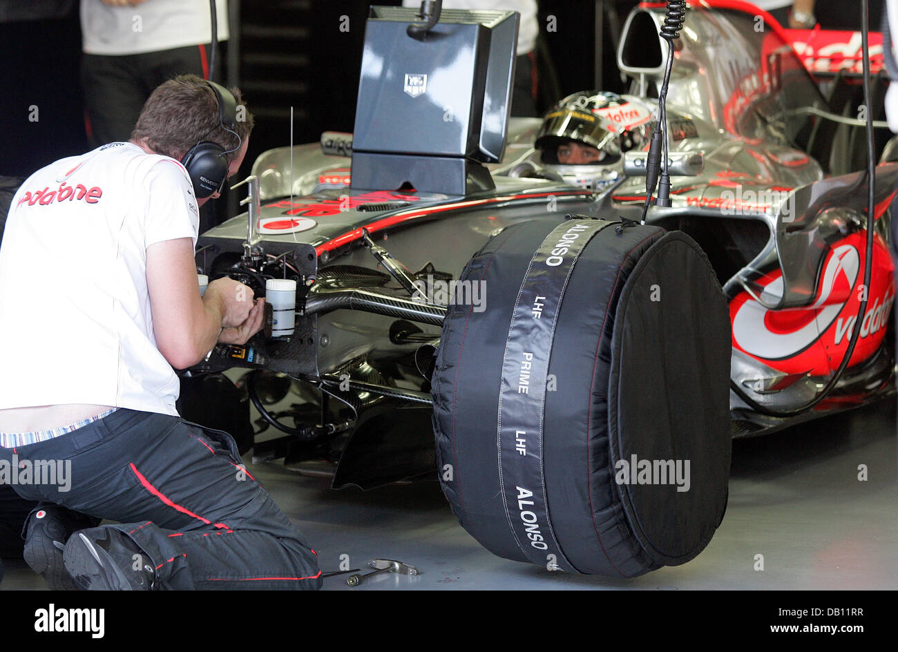 A mechanic of McLaren Mercedes works on the race car of Spanish Formula ...