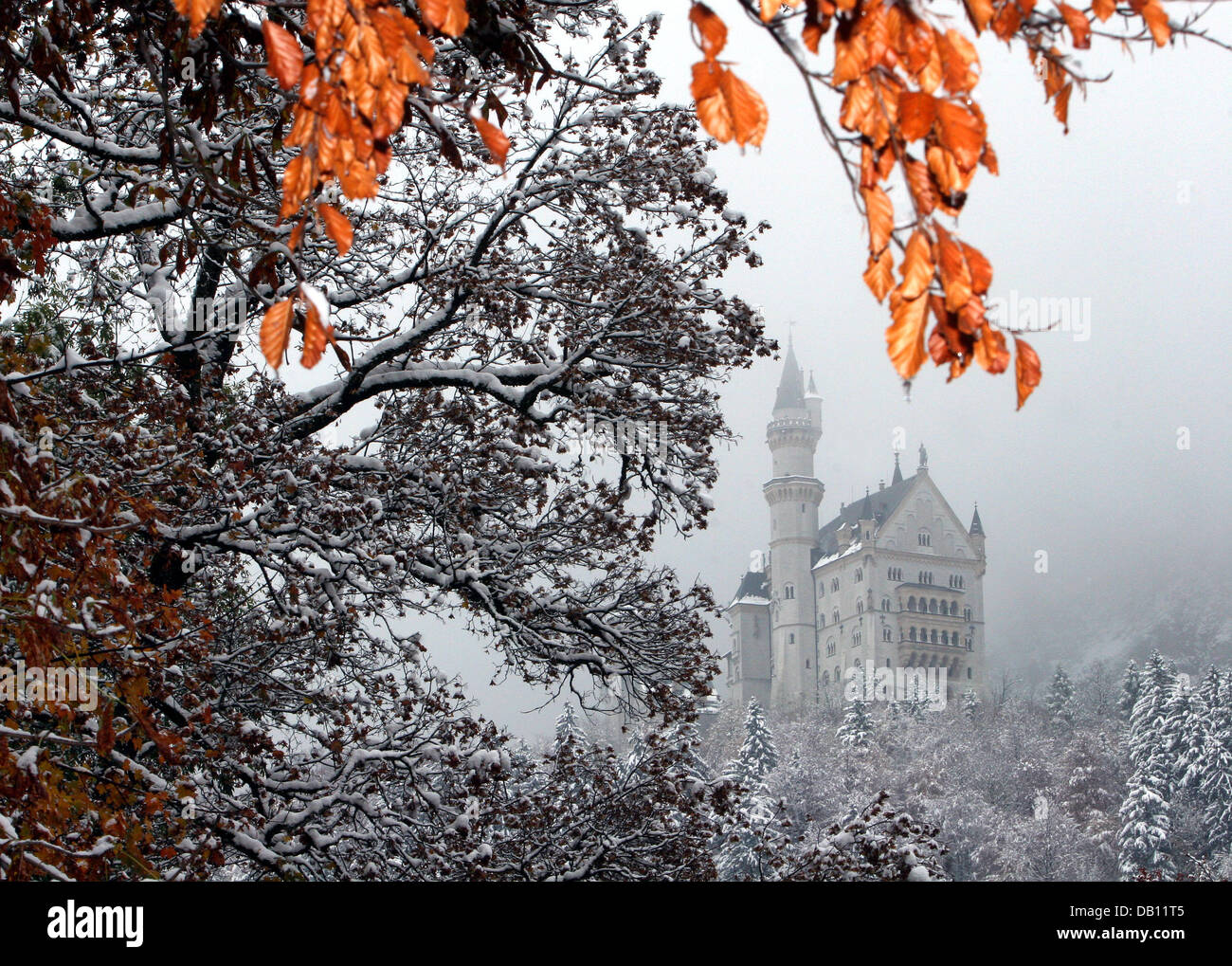 Snow and colourful autumn leaves surround fairy-tale castle ...