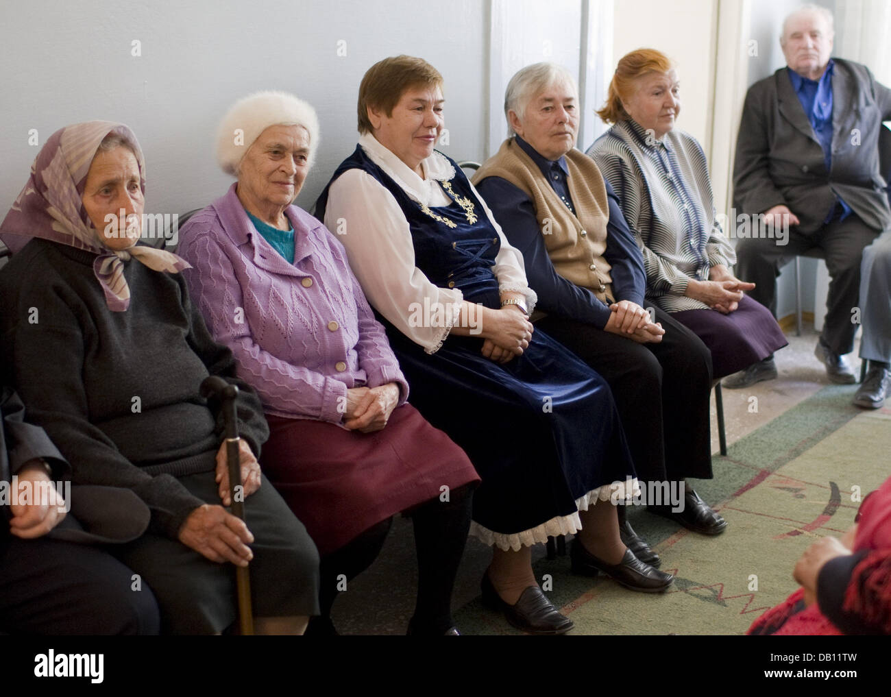 Elderly people of German origin wait at a corridor of a social centre ...