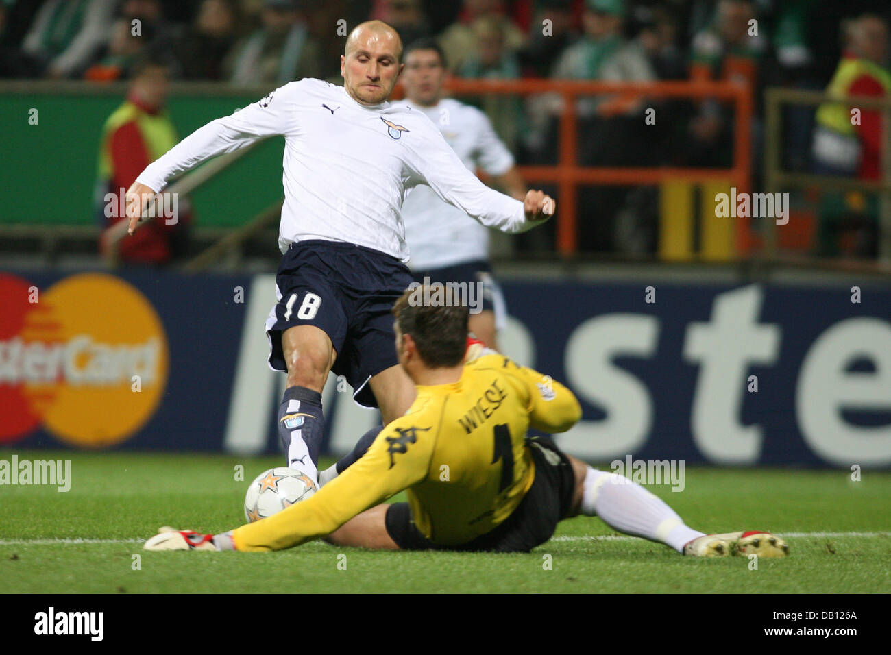 Tim Wiese (bottom), goalkeeper of Werder Bremen, vies for the ball with ...