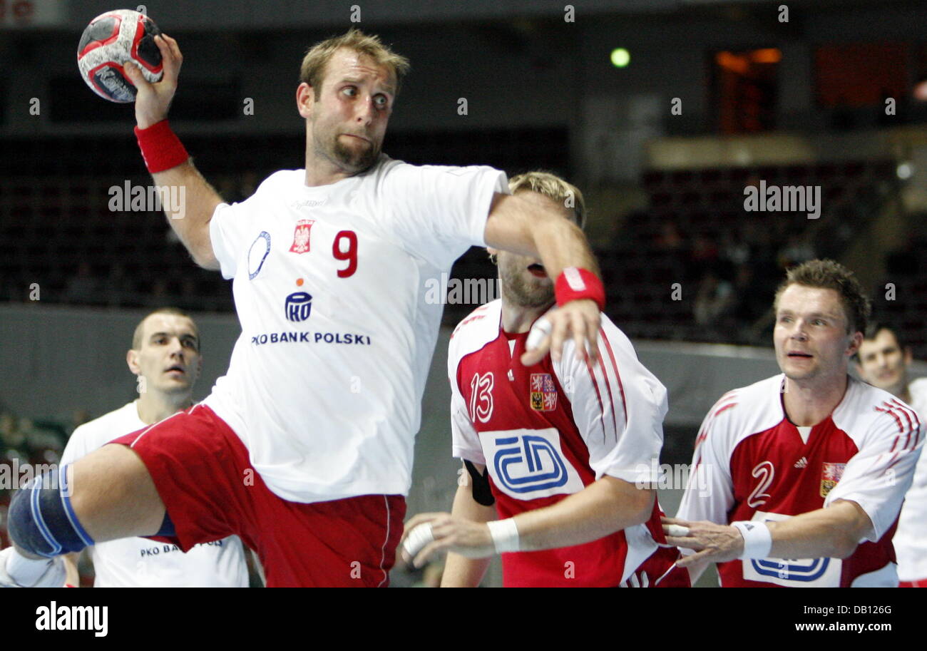 Polish national team player Artur Siodmiak (L) jumps to throw while ...