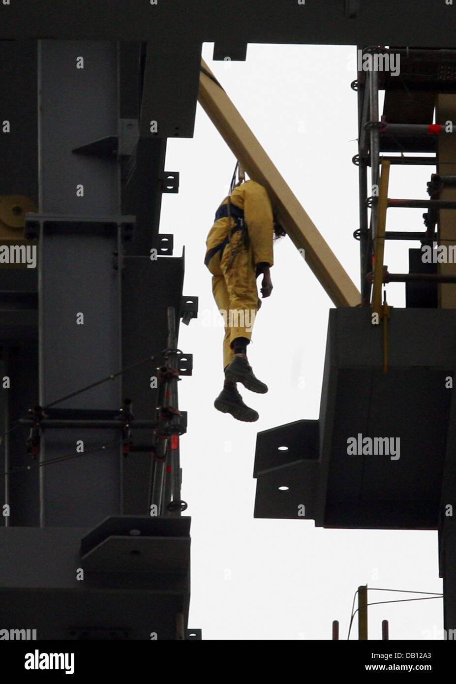 A dead worker hangs in his security harness following a severe accident ...