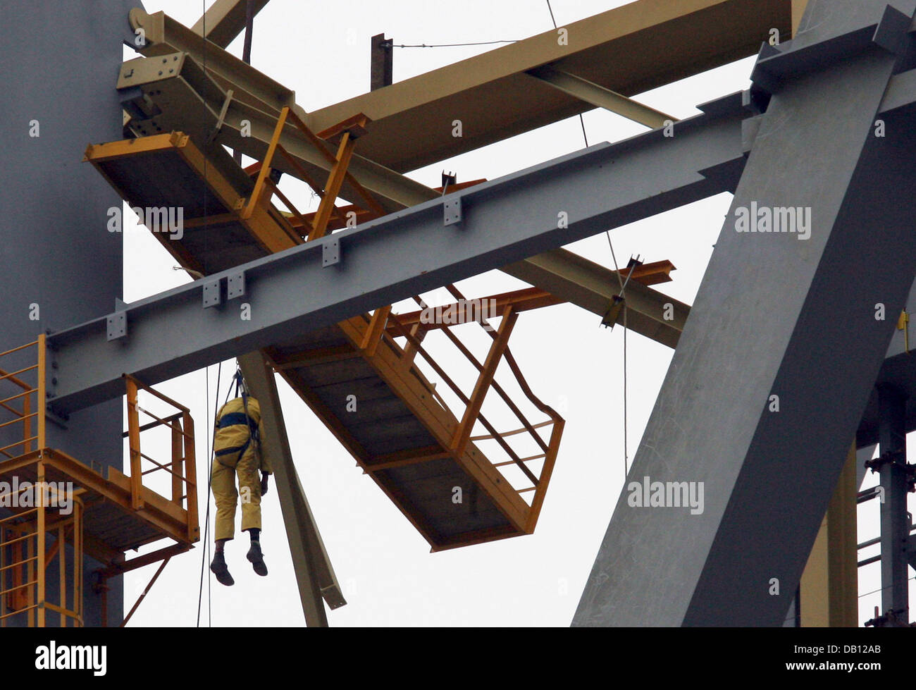 A dead worker hangs in his security harness following a severe accident ...