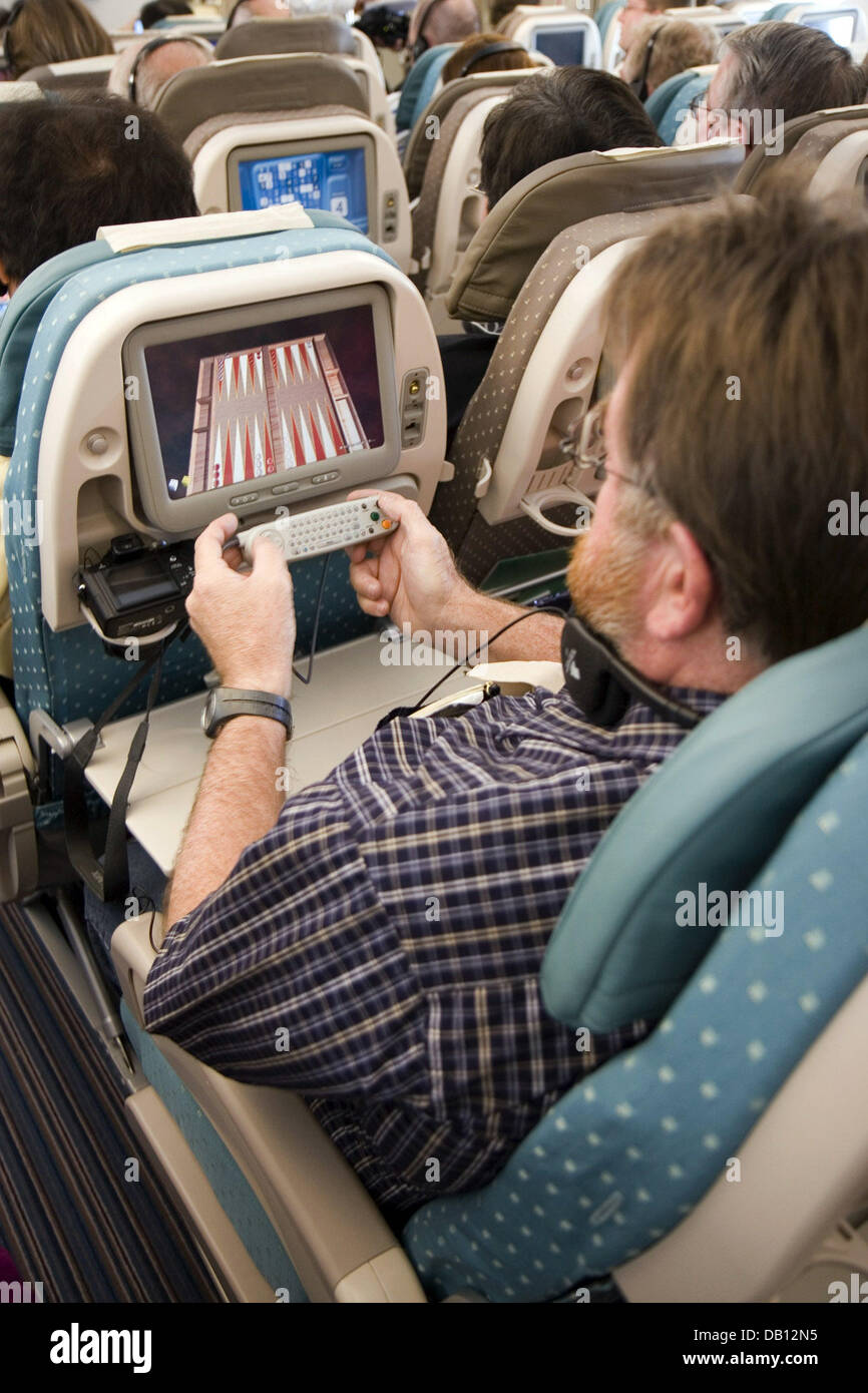 A passenger checks out the Airbus A380?s inflight entertainment system ...