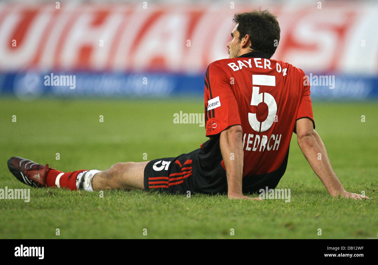 Manuel Friedrich of Leverkusen sits on the grass after the Bundesliga ...