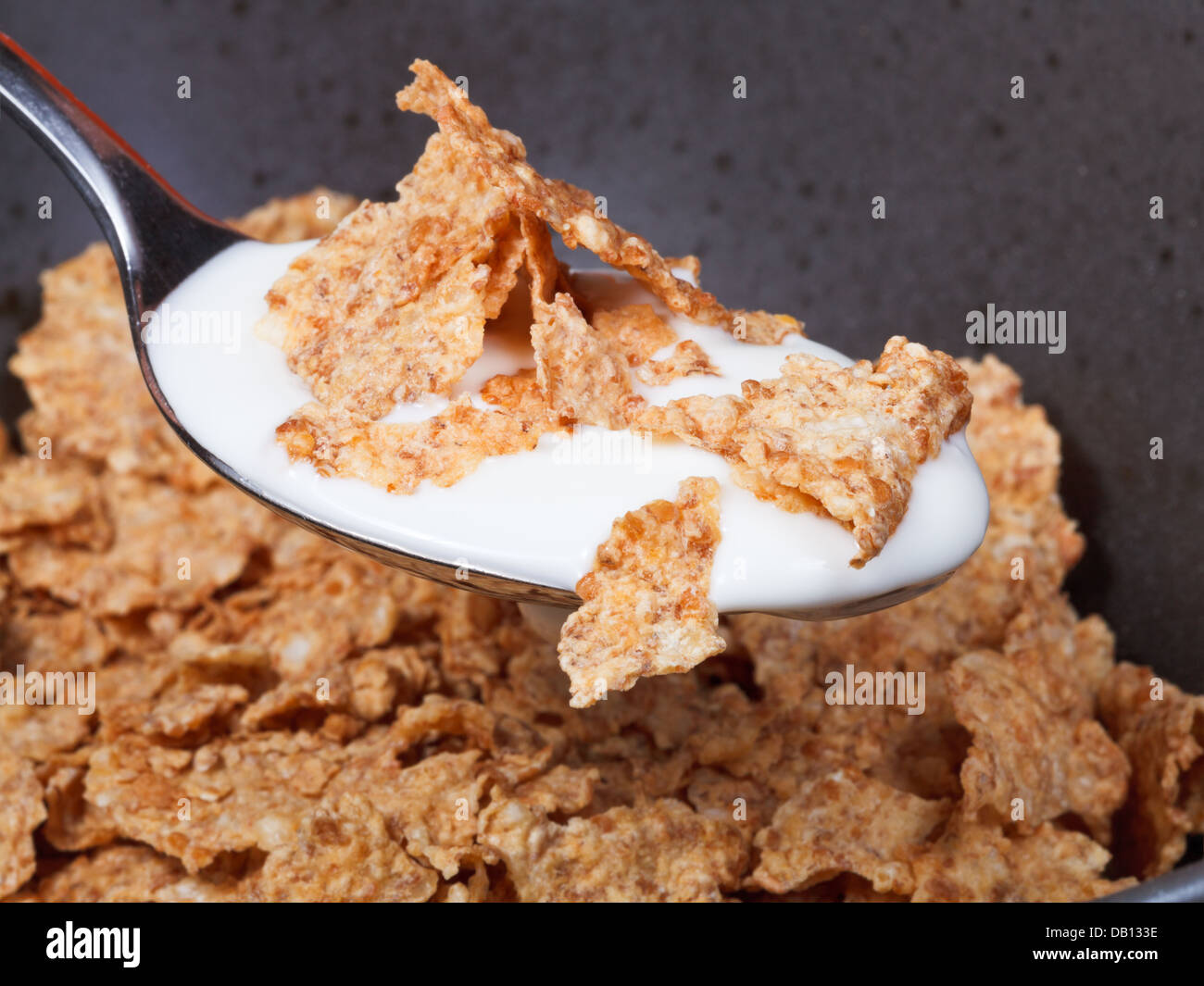 spoon with yogurt and corn flakes close up Stock Photo - Alamy
