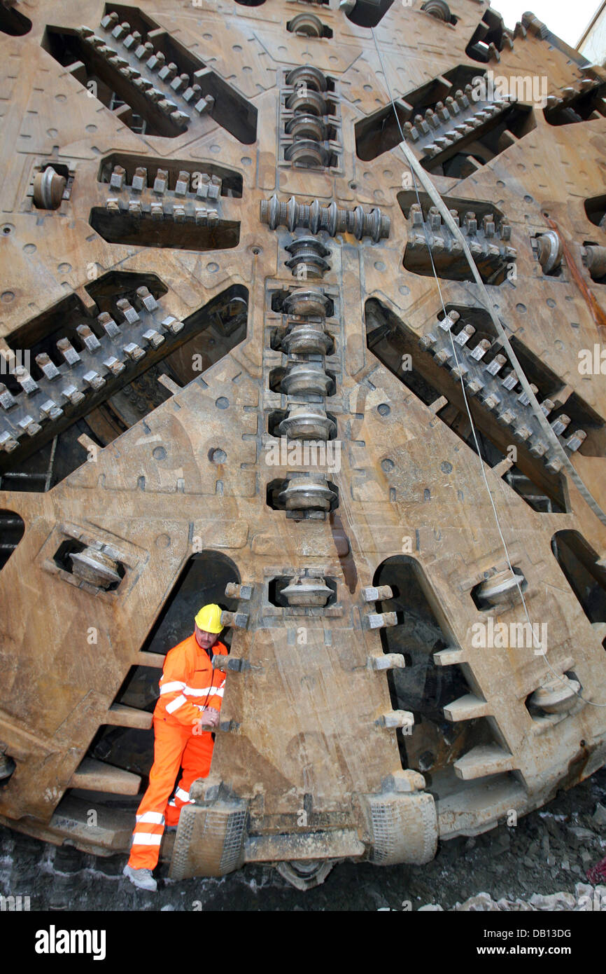 A worker steps out of a tunnel drilling machine at the breakthrough ...