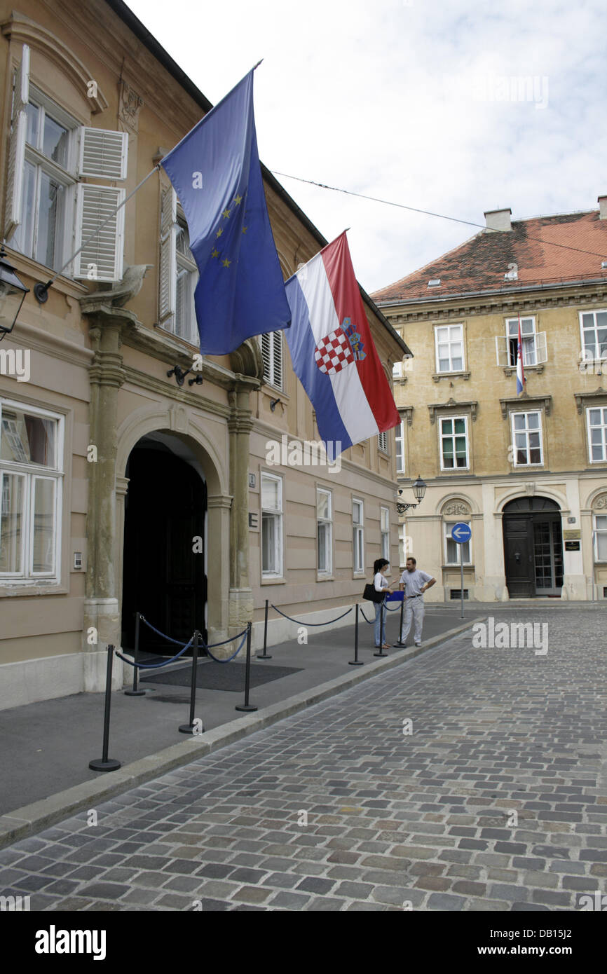 The Croatian (R) and the European (L) flag hang at the Vlada, seat of ...