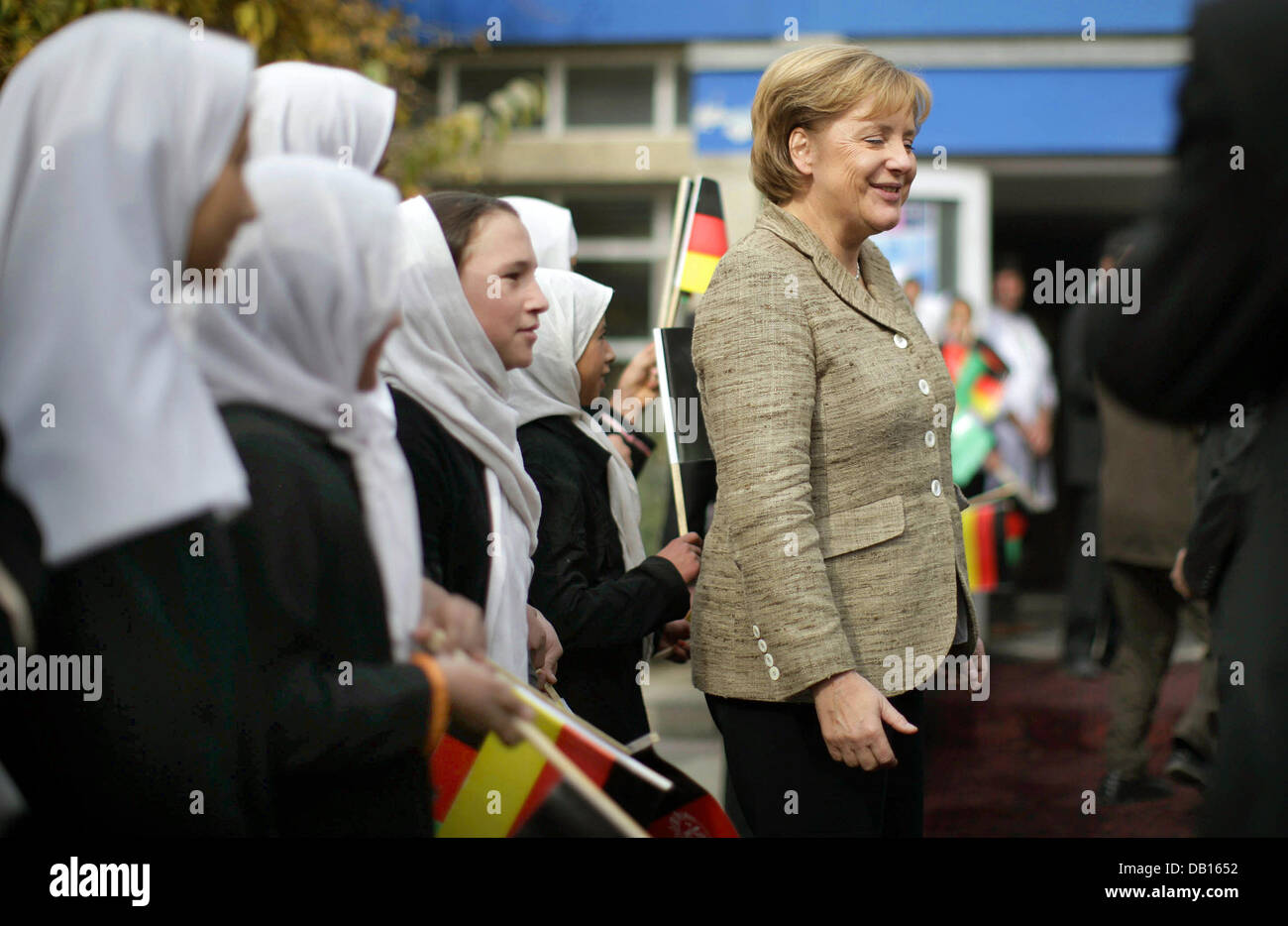 German Chancellor Angela Merkel talks to female students at Amani-high ...