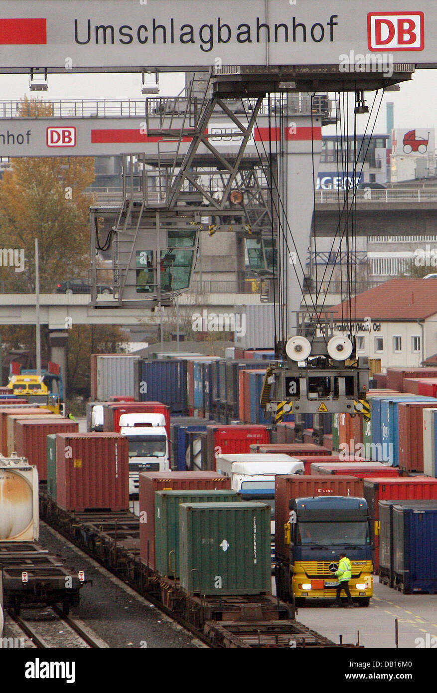 Containers are transshipped from trains to lorries at the railway yard ...