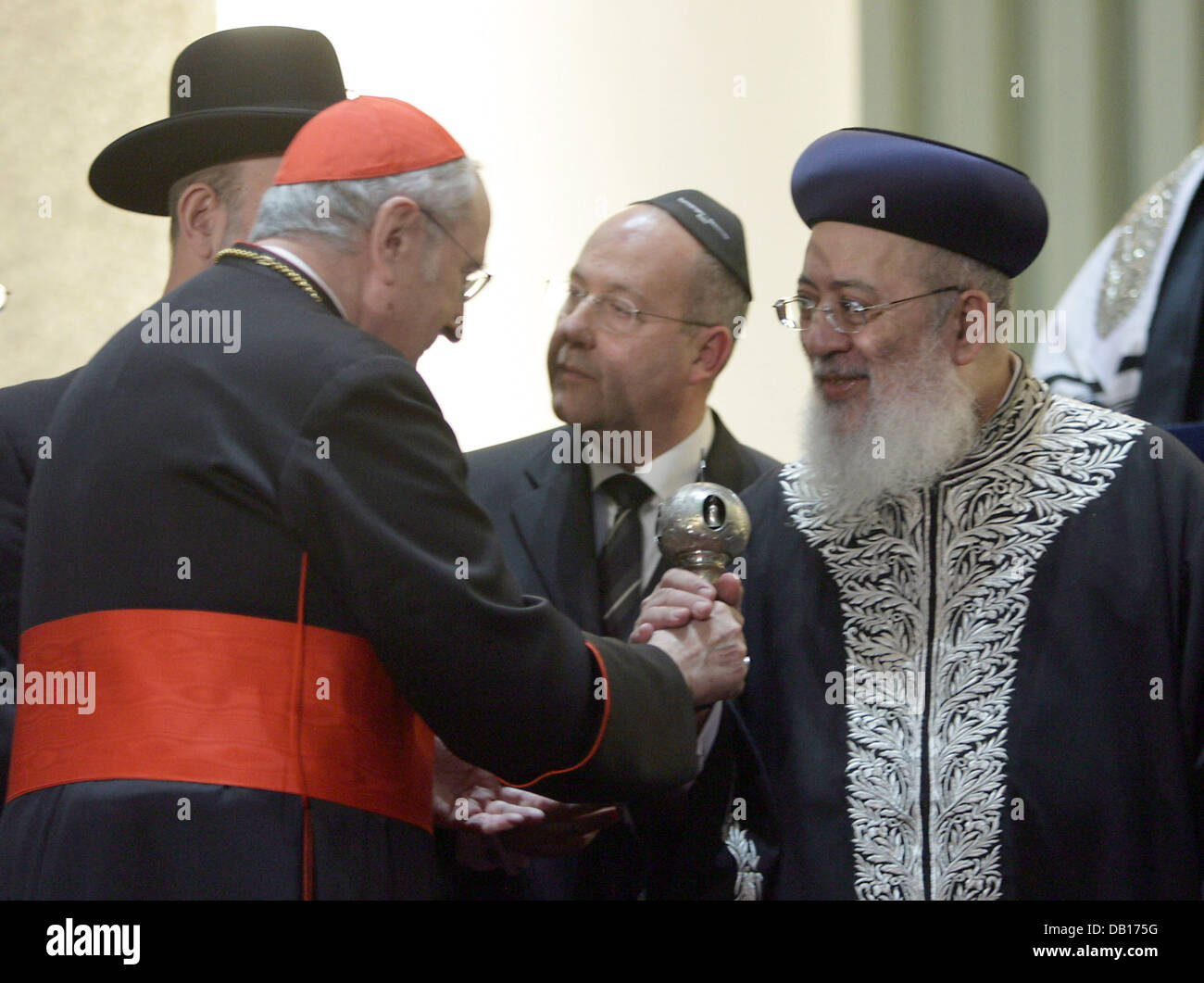 Cologne's cardinal Joachim Meisner (L) hands over the adornment of the ...