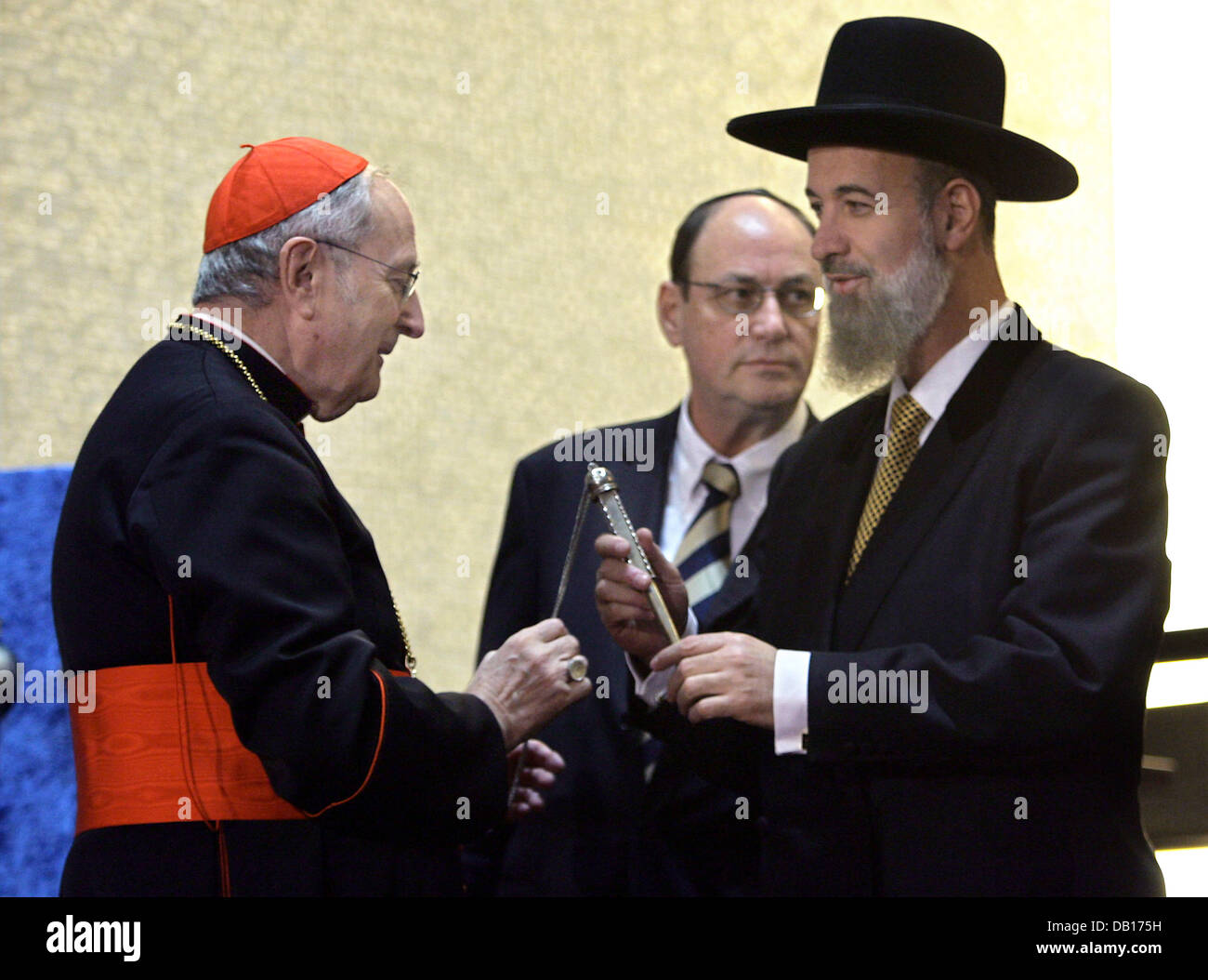 Cologne's cardinal Joachim Meisner (L) hands over the adornment of the ...