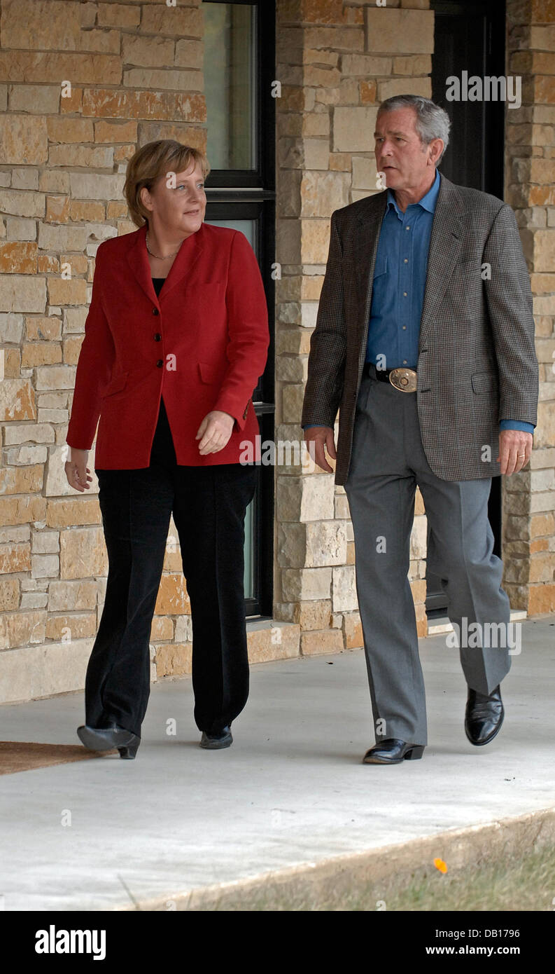 German Chancellor Angela Merkel talks to US President George W. Bush on ...