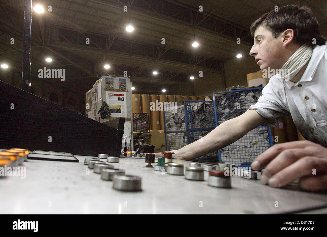 An employee sets the MAN-offset printing machine during the production ...