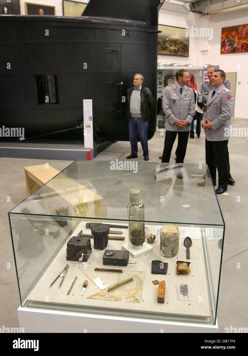 Visitors look at exhibits at the special exhibition on the 100th ...