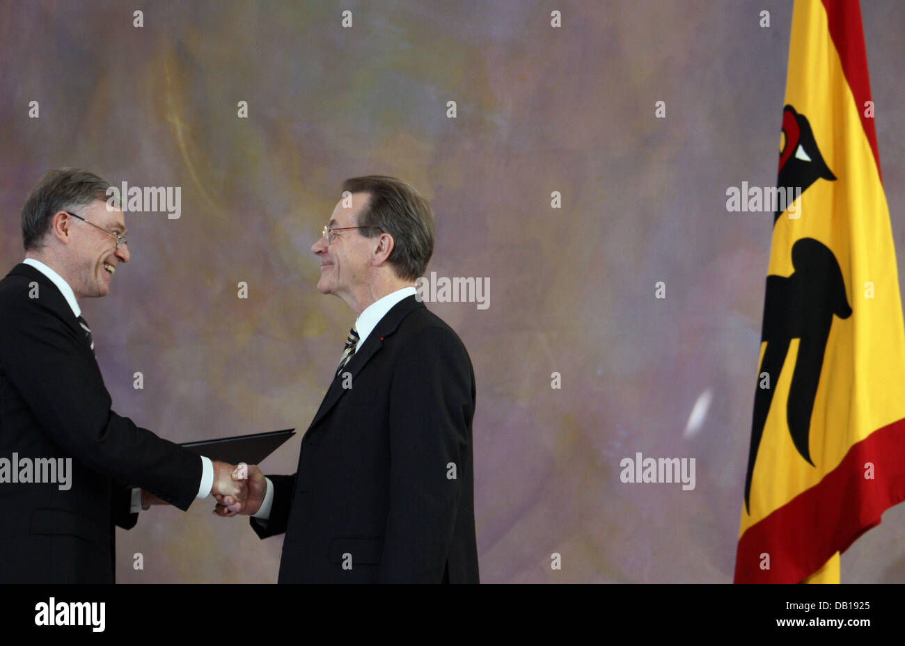 German President Horst Koehler (L) hands over the certificate of ...
