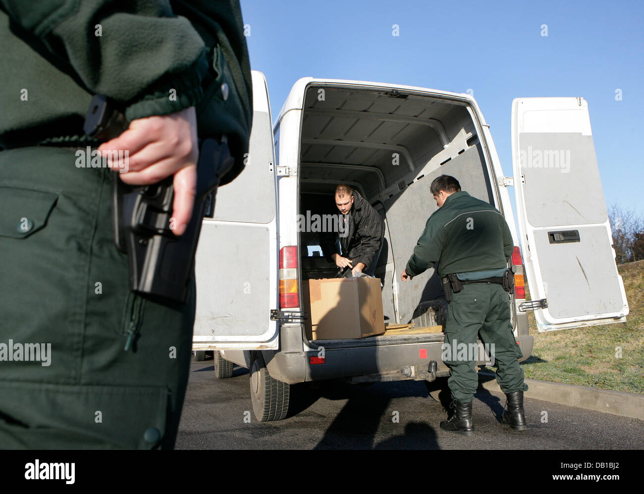 Two German customs officers check a Polish van on autobahn A12 near the ...