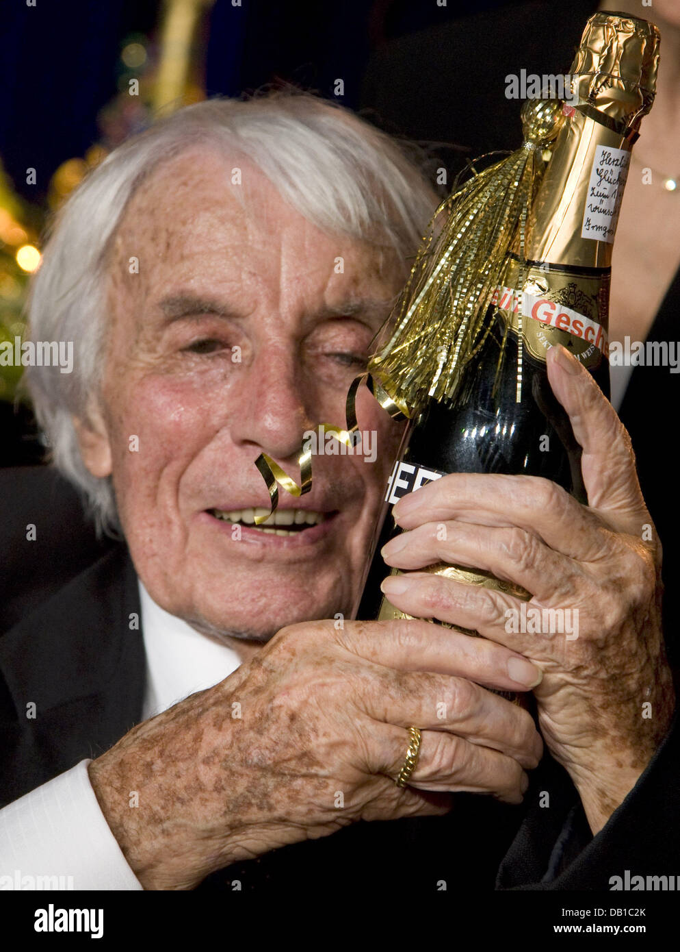 German actor and singer, Johannes Heesters, receives a bottle of ...