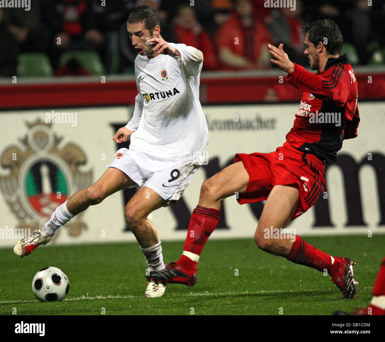 Manuel Friedrich (R) of Bayer 04 Leverkusen vies for the ball with ...