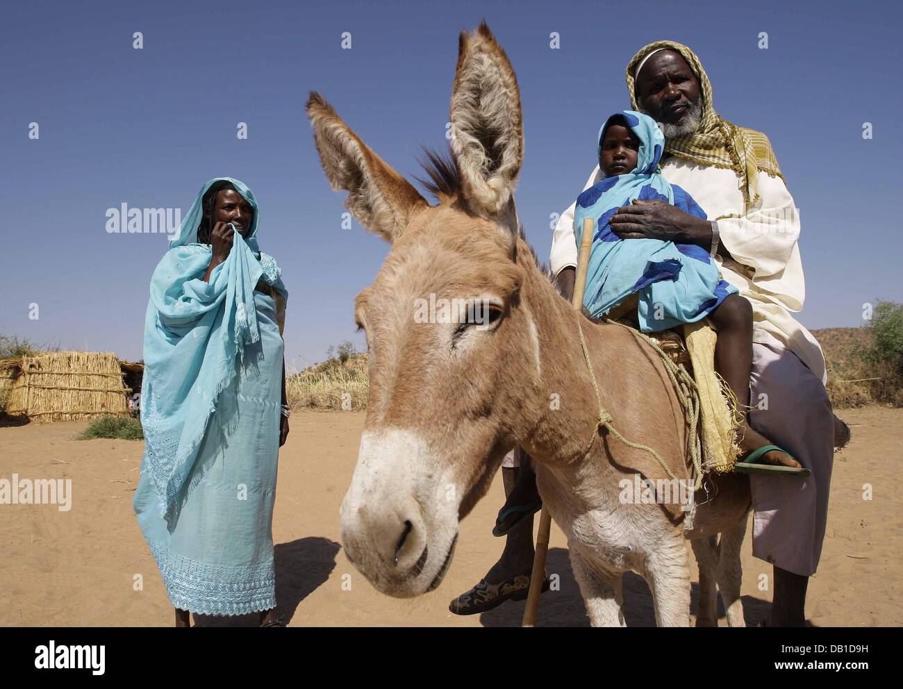 A family takes their sick child on the back of a donkey to the village ...