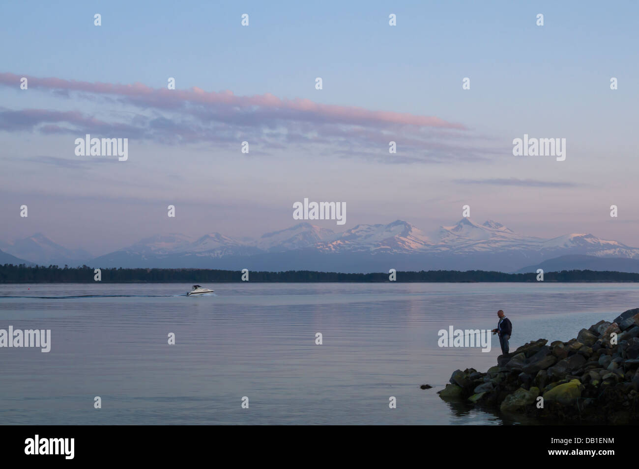 Man fishing with Molde panorama as backdrop Stock Photo - Alamy