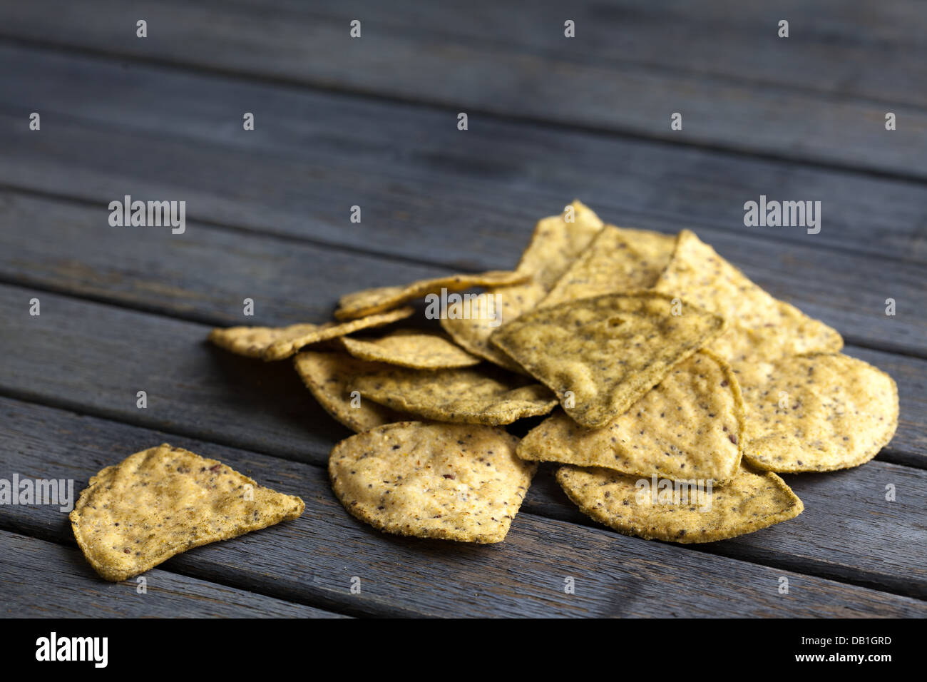 single corn chip next to a pile of chips Stock Photo - Alamy